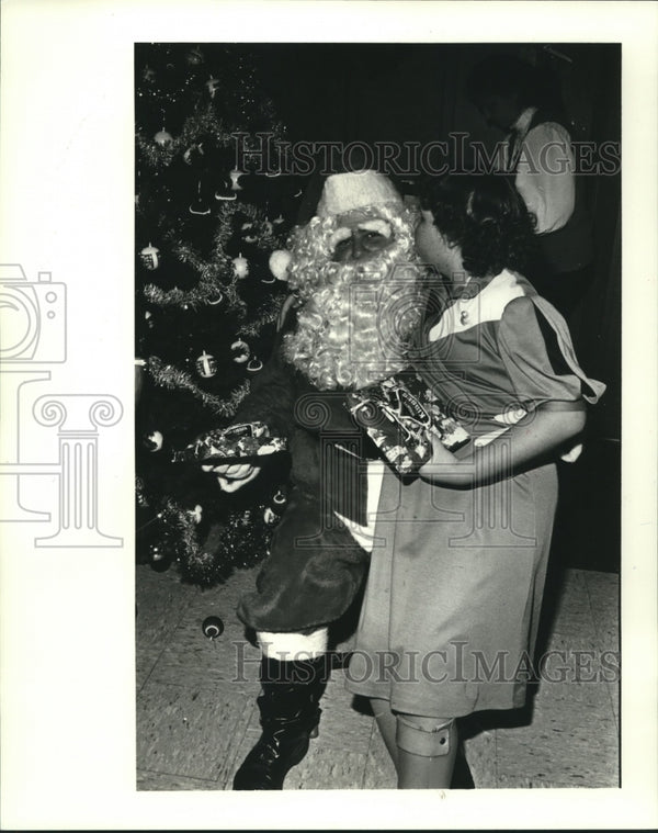1984 Desiree La Bauve kisses Santa at Fradella Hospitality House ...
