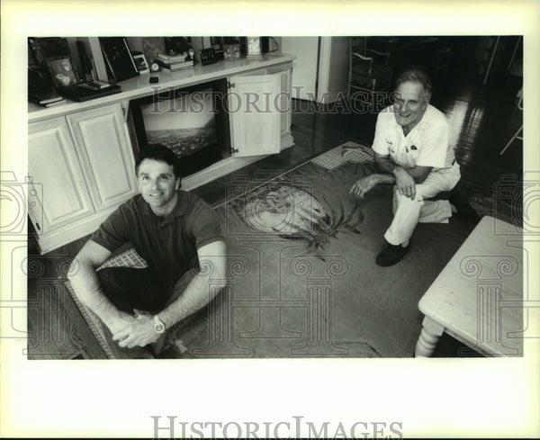 1995 Press Photo Keith Guy and George R. Guy sit on top of a hand pain ...