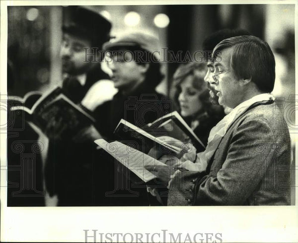 1987 Jefferson Singers caroling at the Place St. Charles lobby ...
