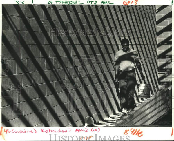 1987 Press Photo Larry Carter of Heritage Electrical Co walks along wa ...