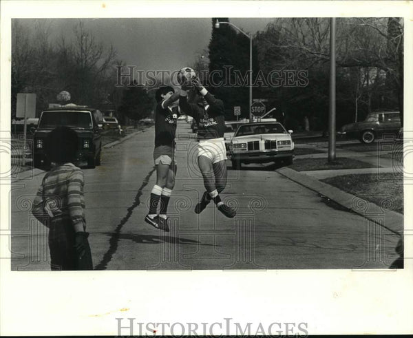 1983 Press Photo Soccer players pose with the ball at the street - noc ...