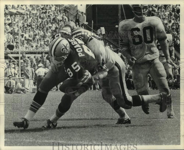 1973 Press Photo New Orleans football player Ray Poage is tackled in a ...