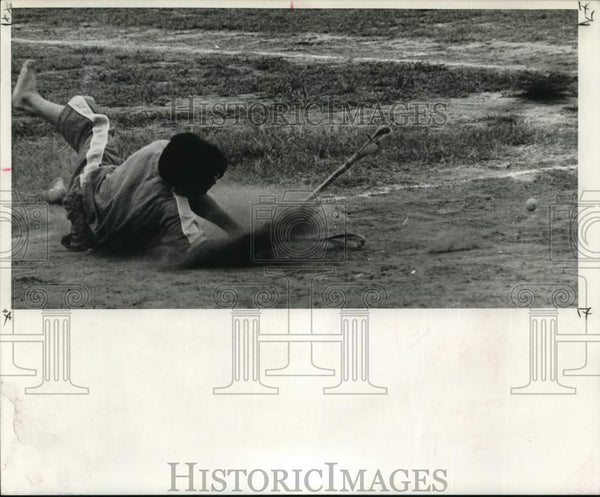1968 Press Photo Stickball's full of spills this player takes one goin ...