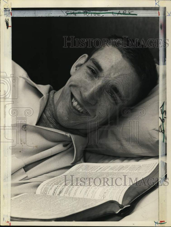 1965 Brian Sternberg reads Bible in bed at home - Historic Images