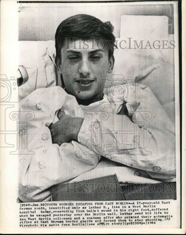 1964 Young man wounded from escaping lies in hospital bed - Historic Images