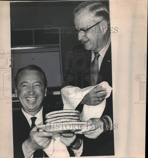 Waggoner Carr served stack of pancakes by man - Historic Images