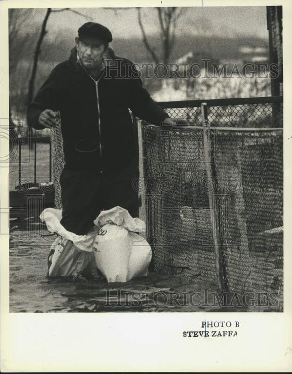 1989 Joe Schulz checks the flood water level, Great Kills - Historic Images