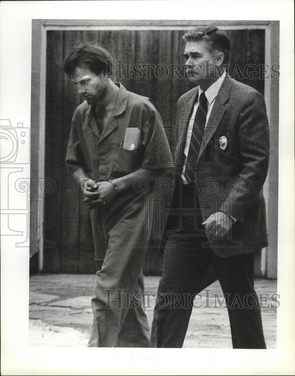 1987 Press Photo Bruce Marchant with assault case is escorted by Jay K ...